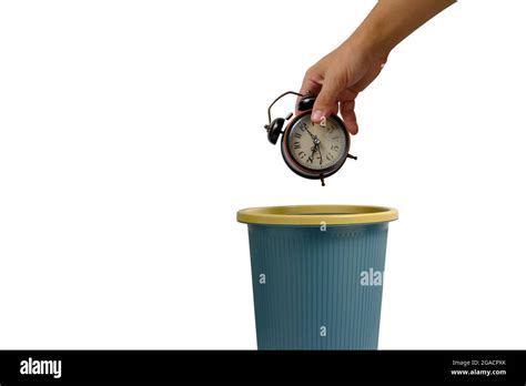 Man Hand Throws An Alarm Clock Set For Eight In Morning Into Trash On White Background Stock
