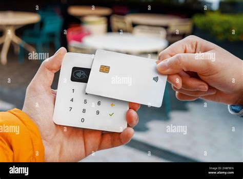 High Angle Of Crop Anonymous Client Making Payment For Order Via White Credit Card Using