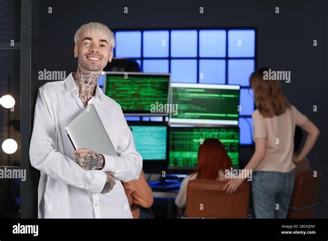 Male Programmer With Laptop In Office At Night Stock Photo Alamy