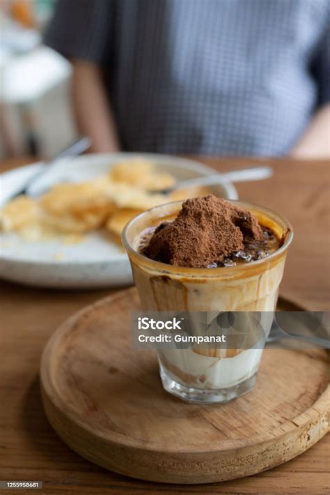 초콜릿 몰트 파우더를 유리 위에 얹은 핫 피콜로 라떼 커피는 나무 테이블에 있는 커피숍에서 특별 메뉴입니다 마실 것에 대한 스톡 사진 및 기타 이미지 Istock