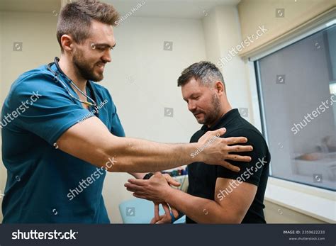 Experienced Physiotherapist Testing Upper Extremity Strength Stock