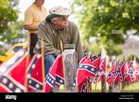 A Descendant Of Civil War Soldiers Kneels At The Tombs Of Confederate