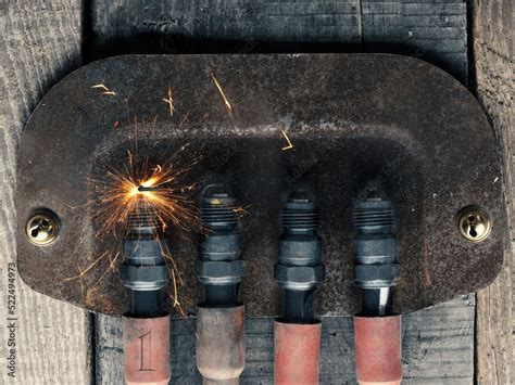 First Advent Background With Four Spark Plugs On Rusty Sign Car