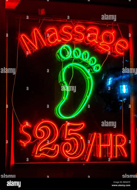 A Neon Sign Advertises Foot Massages For 25 At Treat Your Feet In
