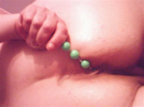 Naked Woman Showing You How To Use Anal Beads On Her Ass