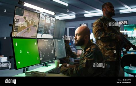 Army Soldier Looking At Chroma Key Screens In Command Center Housing Operational Missile Defense