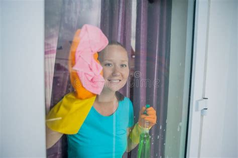 Beautiful Female Maid Doing The Housework While Using A Spray Washing