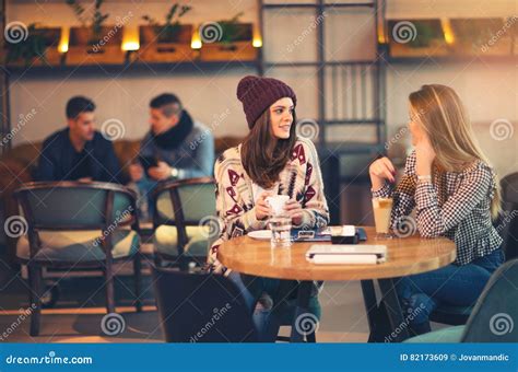 Two Friends Enjoying Coffee Together In A Coffee Shop Stock Image Image Of Friendship Cafe