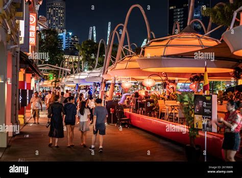 Clarke Quay On Singapore River Illuminated By Coloured Lights With