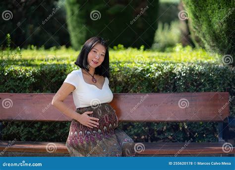 Young Happy And Beautiful Asian Japanese Woman Pregnant Showing Her Belly Proud And Cheerful