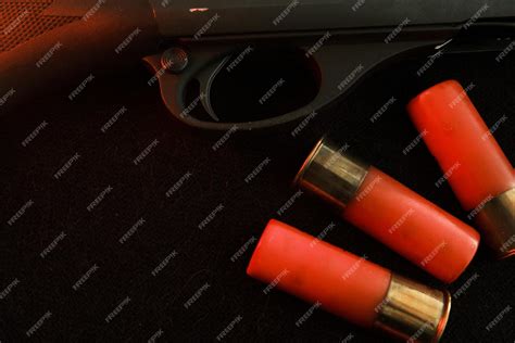 Premium Photo Trigger Of A Rifle On Black Background With Red