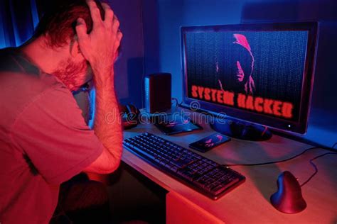 Stressed Man Holding His Head Sitting In Front Of Desktop Computer