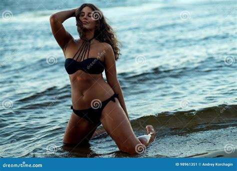 Woman In A Black Bathing Suit Posing In The Water Stock Image Image
