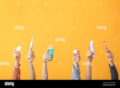 Female Hands With Toothbrushes Paste Mouth Rinse And Dental Floss On