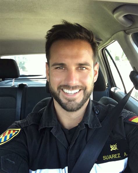 A Man In Uniform Sitting In The Back Seat Of A Car Smiling At The Camera