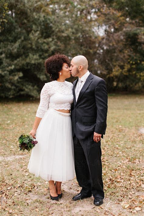 Bride And Groom Kissing In Nature By Stocksy Contributor Kristen