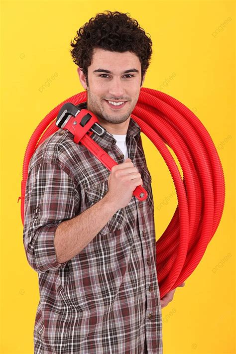 A Pipe Fitting Expert Gripping A Wrench And Measuring Plastic Tube