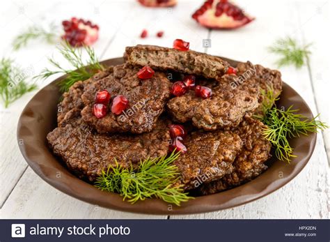 Juicy Liver Cutlets With Pomegranate Seeds On A Ceramic Plate On White