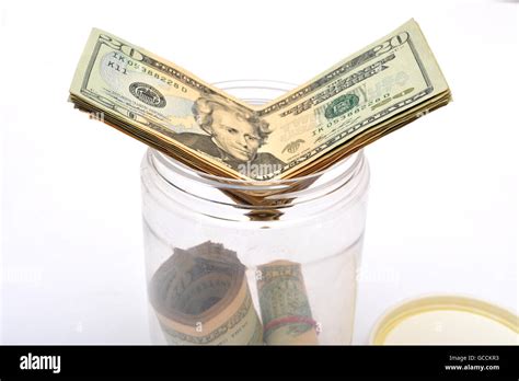 Dollars Going Into A Jar Money Hi Res Stock Photography And Images Alamy