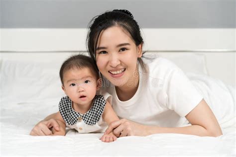 Happy Mother And Baby Lying On Bed At Home Stock Image Image Of