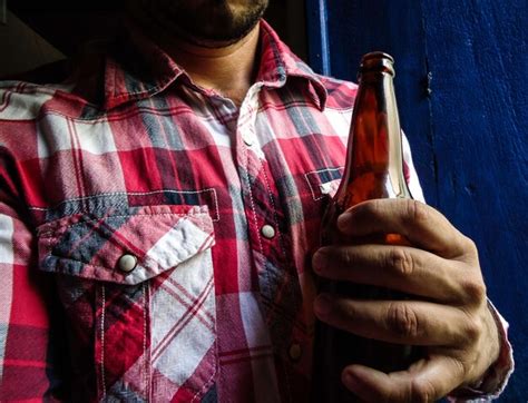 Premium Photo Unidentified Man Holding A Bottle Of Beer