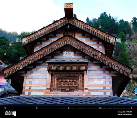 View From Below Of The Side Of A Temple Made Of Mixed Material And Displaying A Beautiful Roof