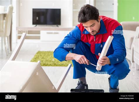 Repair Contractor Repairing Broken Chair At Home Stock Photo Alamy