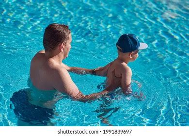 Father Teaching His Son Swimming Stock Photos Images Shutterstock