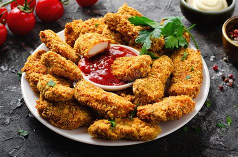 Delicious Crispy Fried Breaded Chicken Breast Strips With Ketchup On