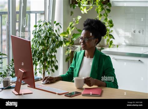 Young African American Woman Secretary Working Sits At Office Desk With