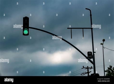 Traffic Light Burning Green On The Dark Clouds Background Traveling