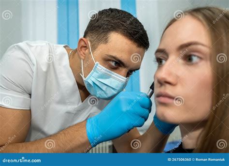 Ent Doctor Examines The Patientand X27 S Ear Using An Otoscope Stock