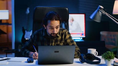 Premium Photo Man At Home Paying Attention In Elearning Seminar Writing Homework