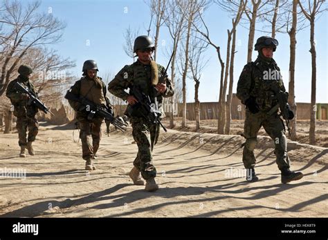 A Group Of Afghan National Army Soldiers Advance The Formation During A