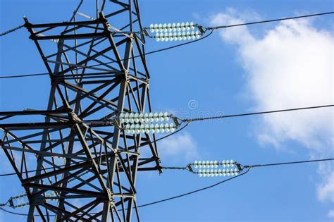 High Voltage Tower With Electrical Voltage Wires Isolates Close Up Against The Background Of