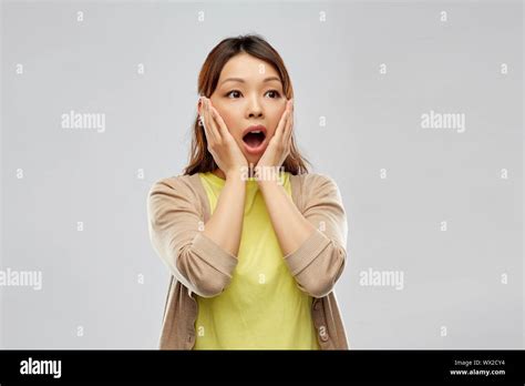 Scared Asian Woman Over Grey Background Stock Photo Alamy