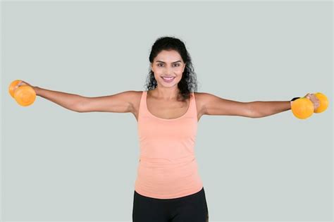 Premium Photo Pretty Girl Doing Exercises With Two Dumbbells