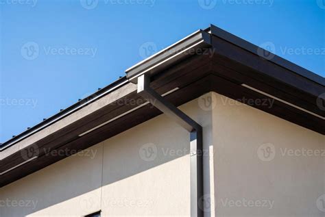 Modern House Corner Featuring A Charcoal Grey Rain Gutter System And