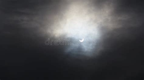 A Solar Eclipse In Cloudy Weather Through A Cloud Partial Solar