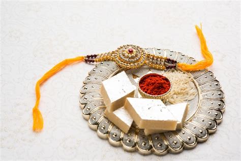 Premium Photo Raksha Bandhan Greeting Rakhi And T With Sweet Kaju