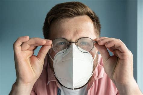 Man In Foggy Glasses Due To Wearing A Medical Mask He Feels Discomfort Trying To See Something