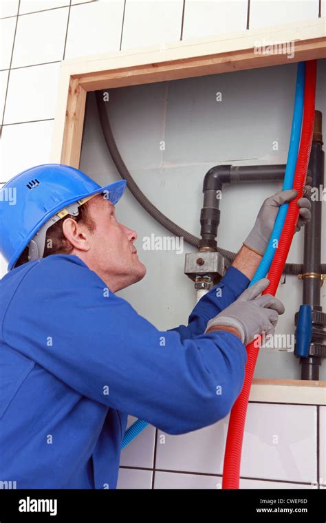 45 Years Old Plumber Connecting Pipes Stock Photo Alamy