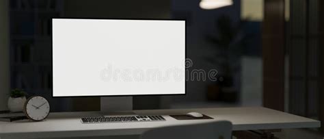 A PC Computer White Screen Mockup On A White Desk In A Modern Dark Office Room At Night Stock