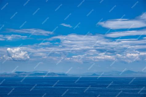 Premium Photo Blue Sea And Sky Background Blue Shades And White Clouds