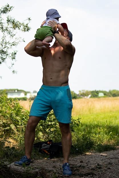 Premium Photo Full Length Of Shirtless Father Playing With Son While
