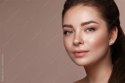 Beautiful Young Girl With Natural Nude Make Up With Cosmetic In Hands