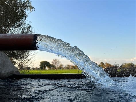 Premium Photo Water Pouring From A Pipe Into A Pool