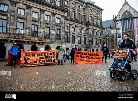 People Are Holding Big Banners In Support Of Refugees And Against