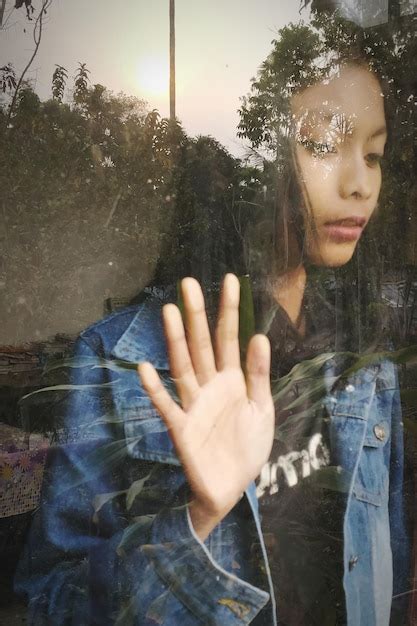 Premium Photo Teenage Girl Looking Through Window