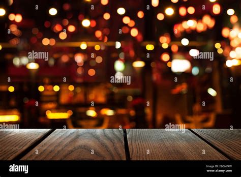 Blur Bokeh Of Bar Or Club Party Dark Night Light Background With Wood
